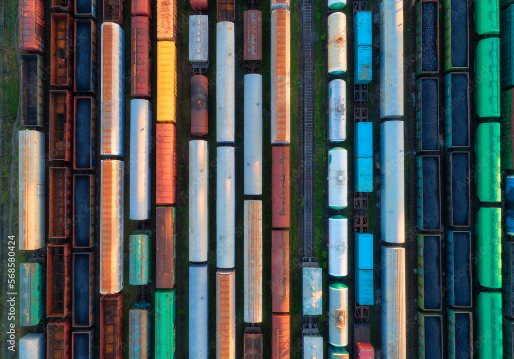 Aerial view of freight trains at sunset. Colorful railway cargo wagons ...