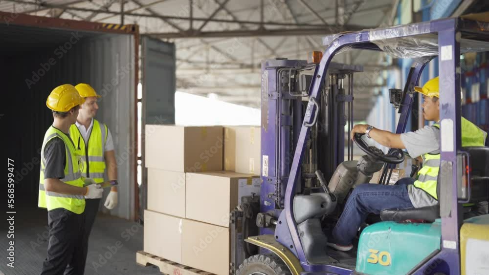 Teamwork of workers driving Fork lift truck with pallet car vehicle in ...