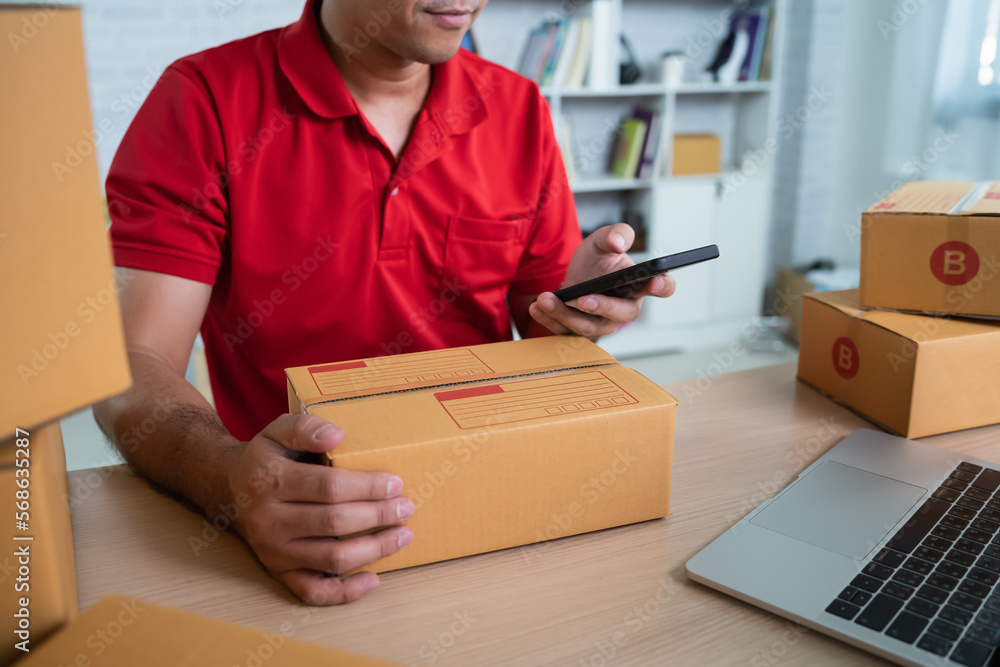 Asian delivery man worker smiling using mobile scan barcode for boxes ...