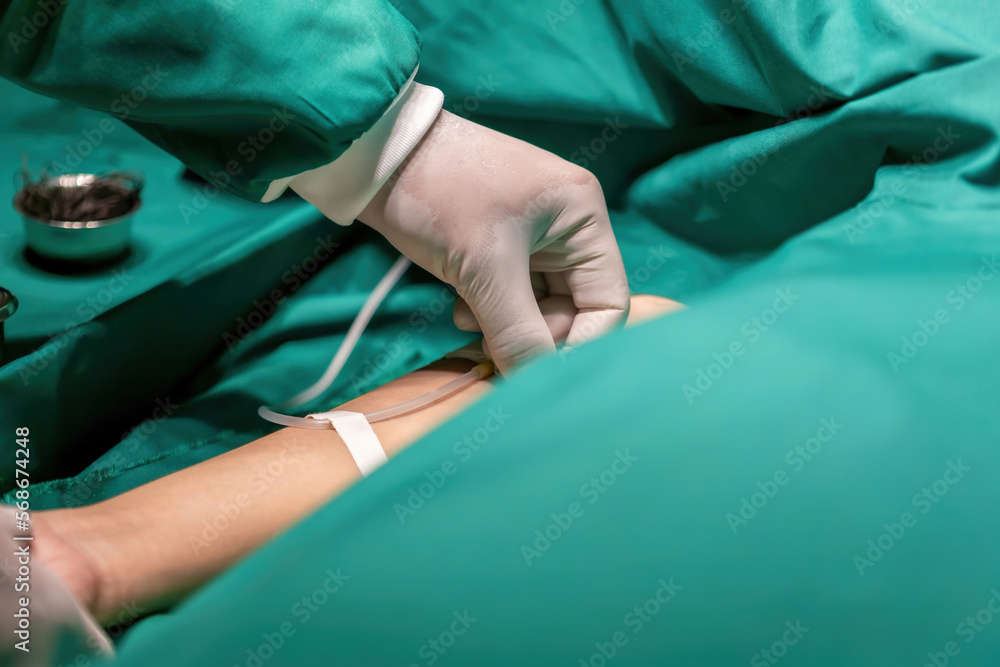 surgeon group tape tube patient arm for infusion therapy. team of ...