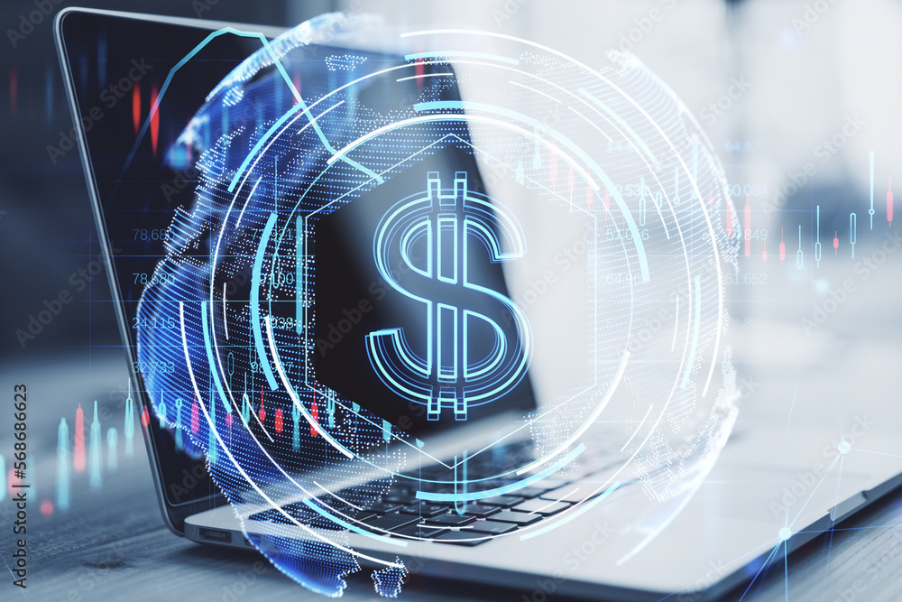 Close up of laptop computer with glowing dollar hologram on blurry ...