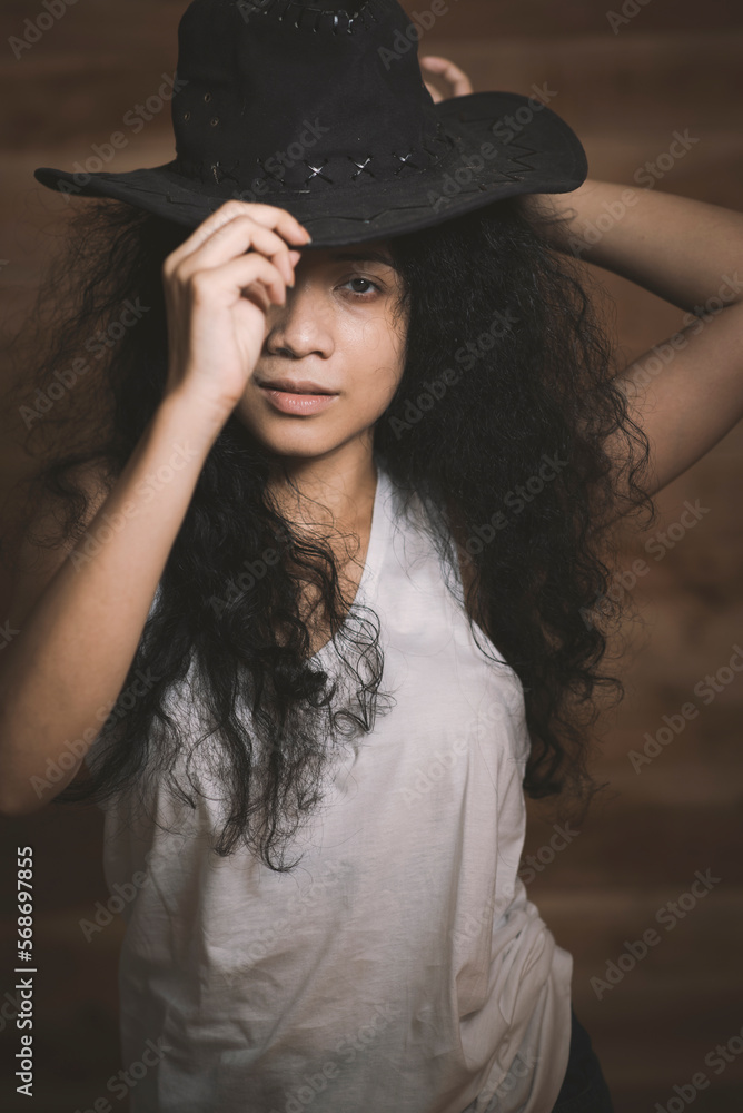 Curly hair girl in cowboy hat Stock Photo | Adobe Stock