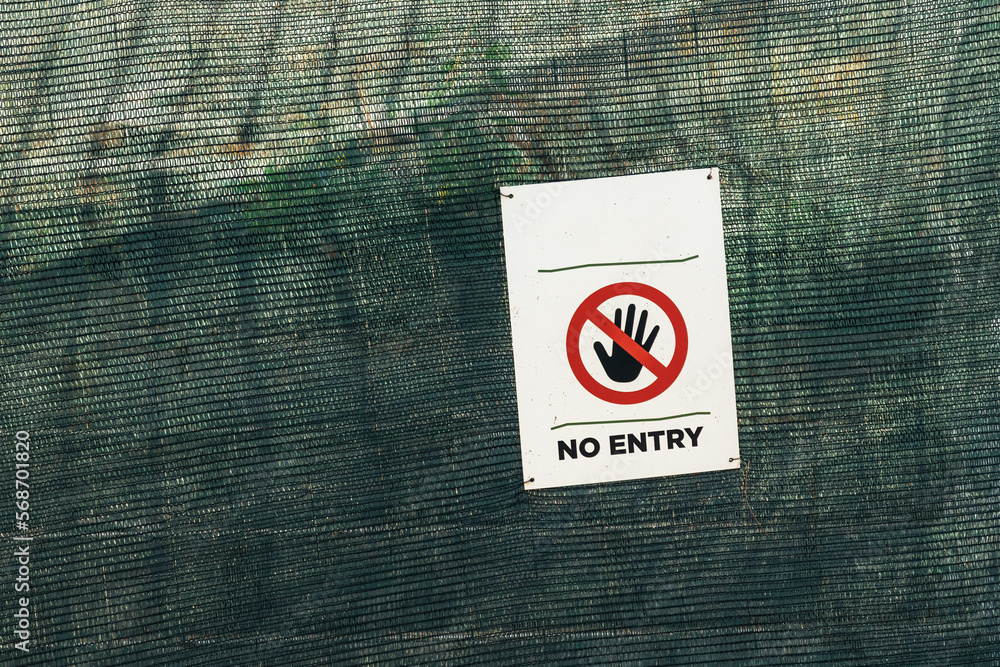 No entry sign with Stop hand gesture on fence Stock Photo | Adobe Stock