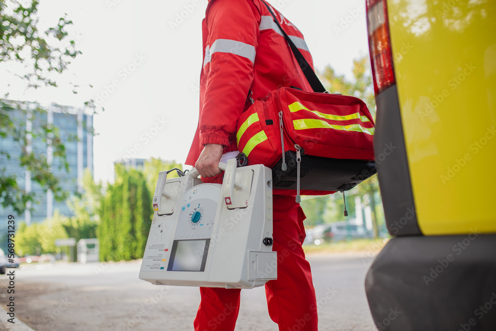 Hand of the doctor with defibrillator. Teams of the Emergency medical ...