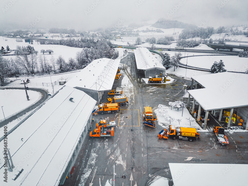 Workers on the highway maintenance base having a busy day, with snow ...