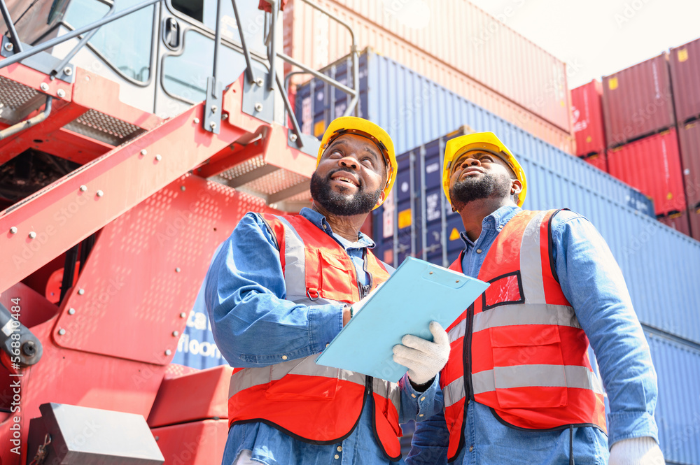 Two African American logistic workers wearing reflective vests and ...