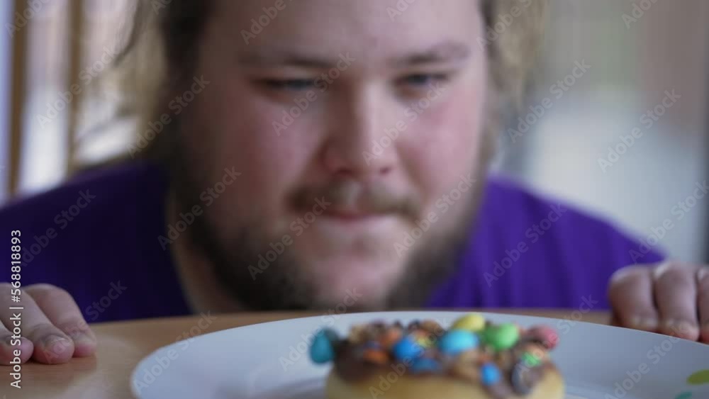 Overweight Person wanting to eat sugar food on plate. One Young fat man ...