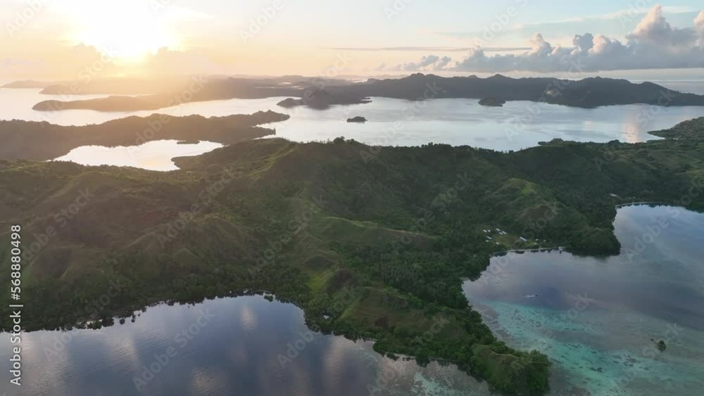 A serene sunrise illuminates tropical scenery in the Solomon Islands ...