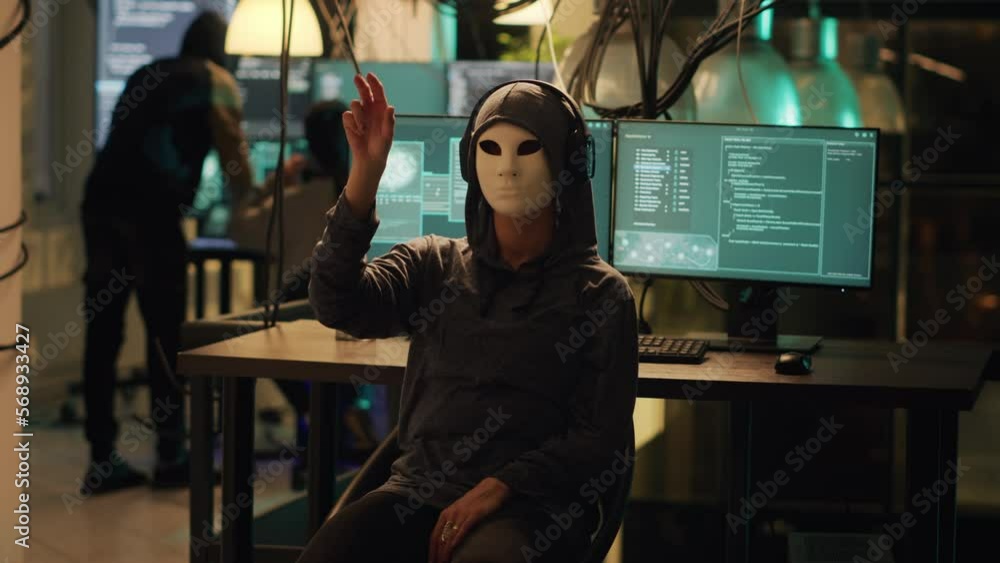 Female hacker with anonymous mask using hologram to break into firewall ...