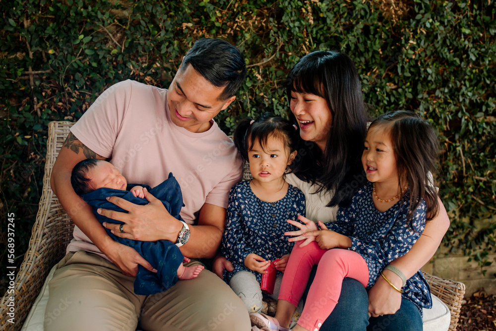 Happy family admiring their newborn baby together Stock Photo | Adobe Stock