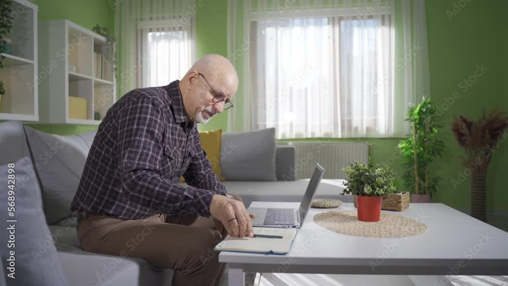 Frustrated old man working on laptop at home. Frustrated and senile old ...