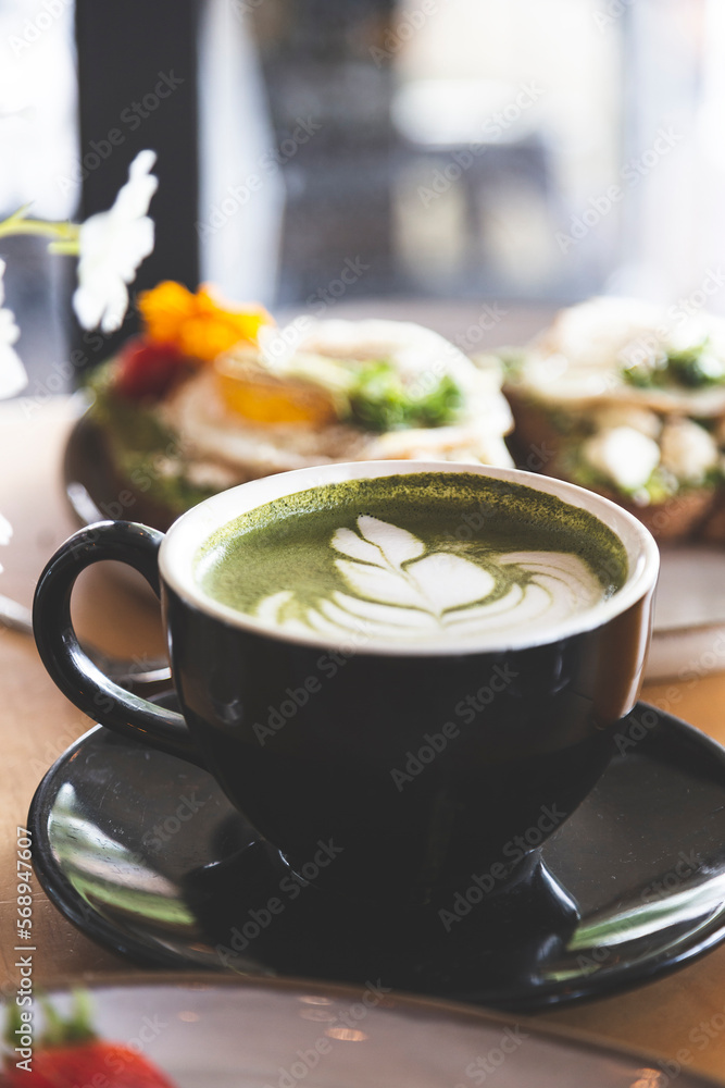 Table full of food and coffee prepared by a barista in a black cup on a ...