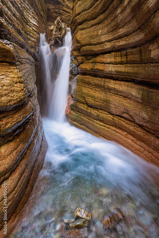 Wasserfall in der roten Klamm des Taugl Wildbachs Stock Photo | Adobe Stock
