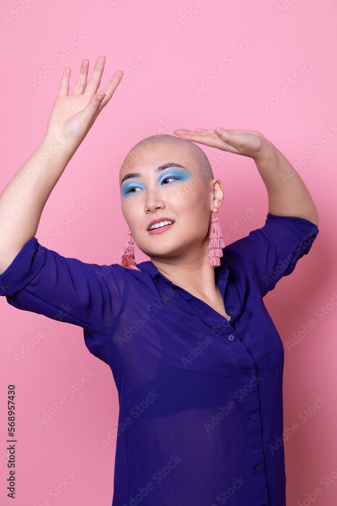 Stylish Gen Z woman making gestures in front of Pink backdrop Stock ...