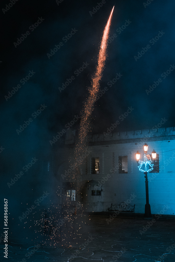 Fireworks going from the launching platform leaving a trail of sparks ...