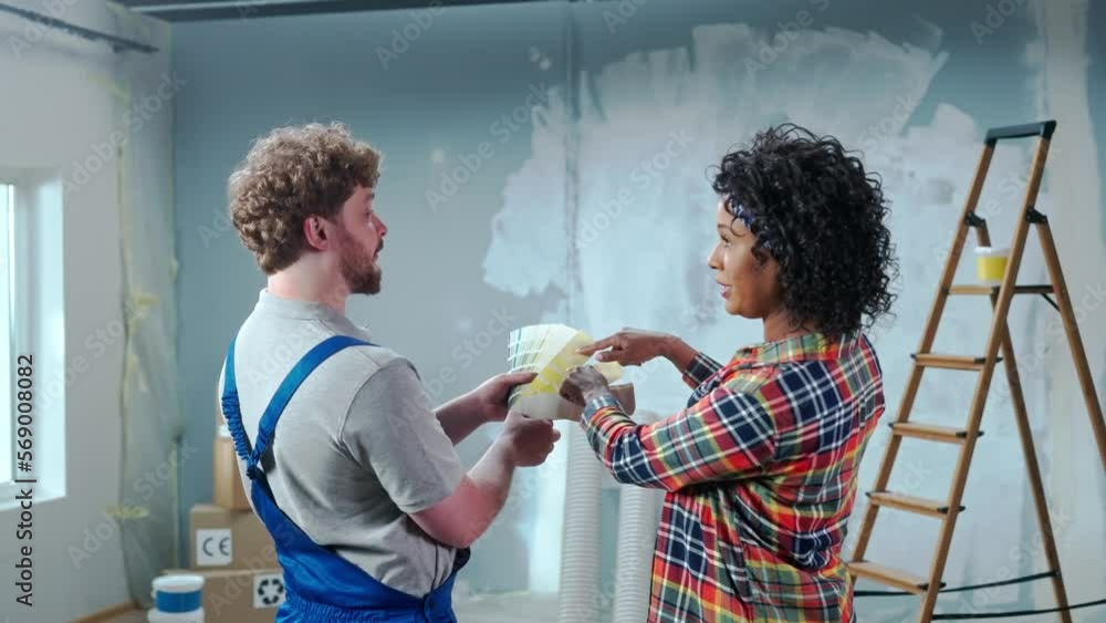 Customer is an African American woman and white male foreman choosing ...