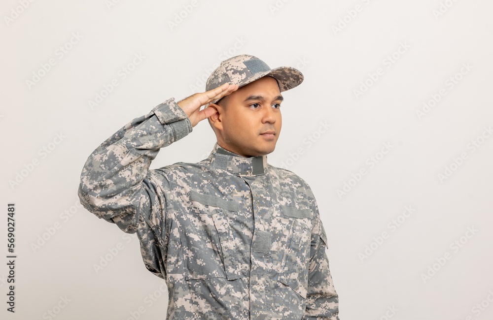 Saluting Asian man special forces soldier standing in studio. Commander ...