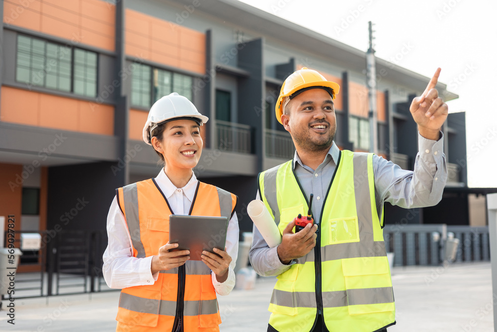 Two Asian worker engineer architect man and woman architect looking ...