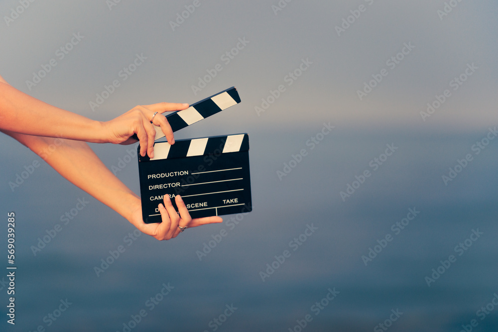 Hand Holding a Cinema Film Slate at the Seaside Beach. Professional ...