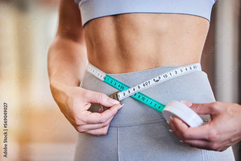 Tape measure, stomach and woman at gym for weight loss, diet or ...