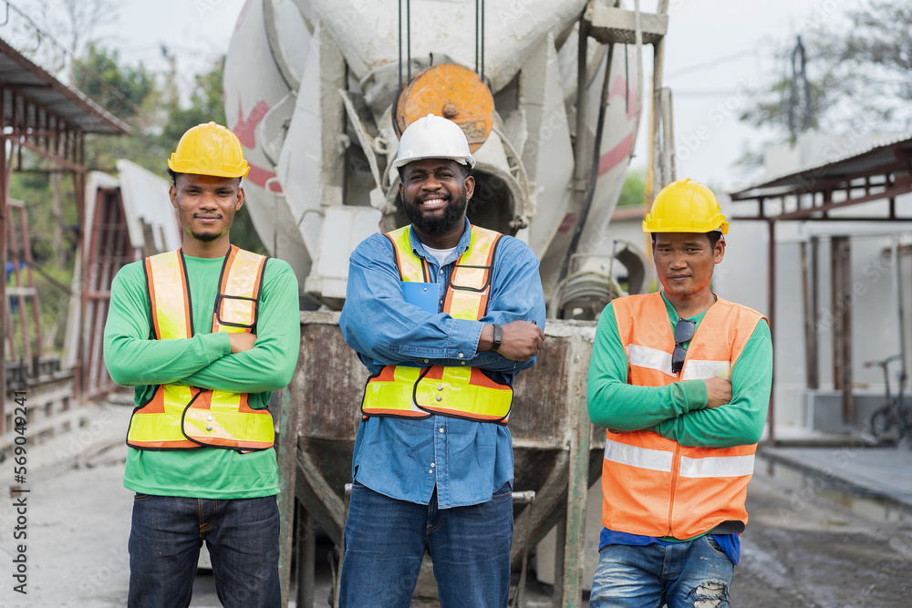 Portrait of foreman builder and workers standing together at ...