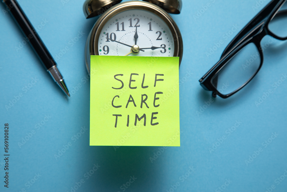 Self care time on sticky note with a clock and business objects. Stock ...