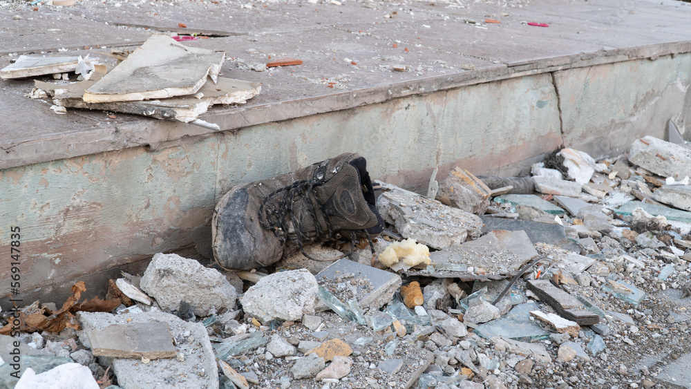 Shoe in debris in Russia Ukraine war. War concept. Male shoe under ...