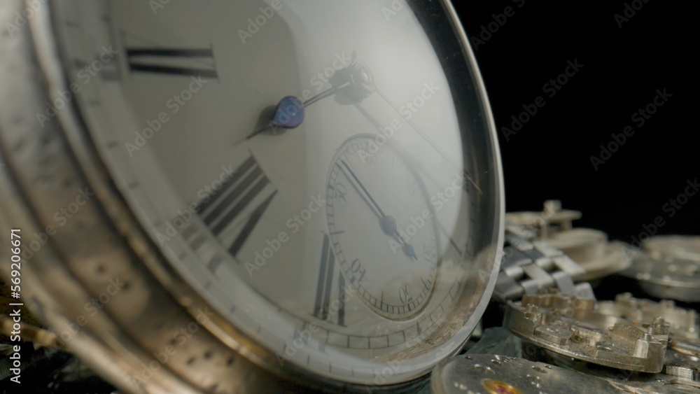 Grey vintage pocket watch dial on pile of clockwork parts. Round old ...