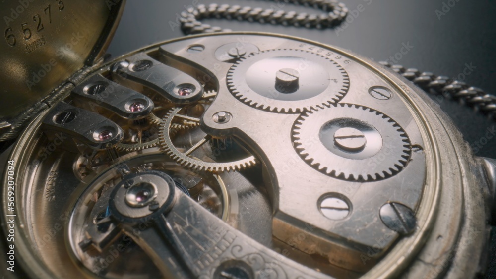 Internal working mechanism of an antique pocket watch on a gray ...