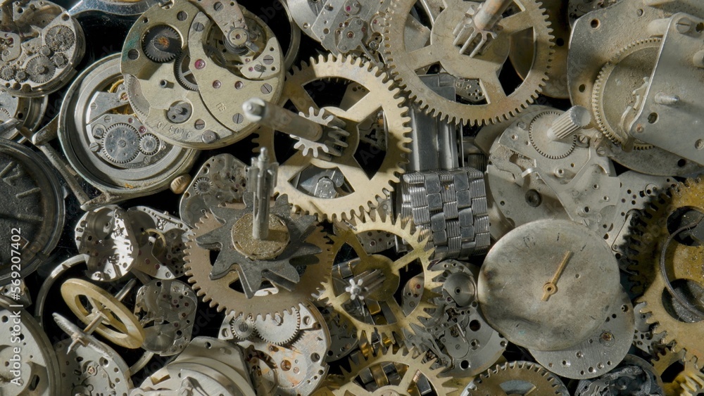 A pile of metal internal parts of an old clock. Dial, clockwork ...