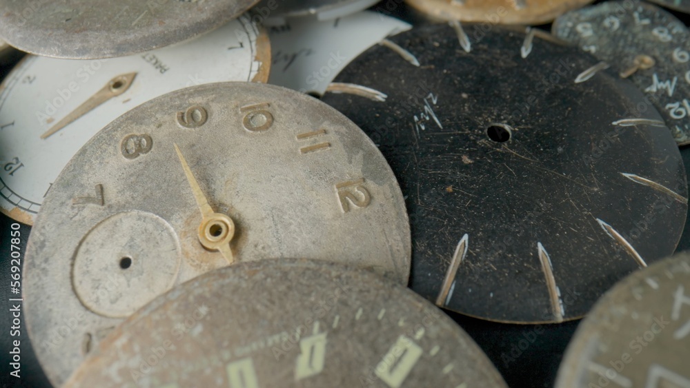 Old worn clock dials. Aged scratched round watch faces with hands and ...