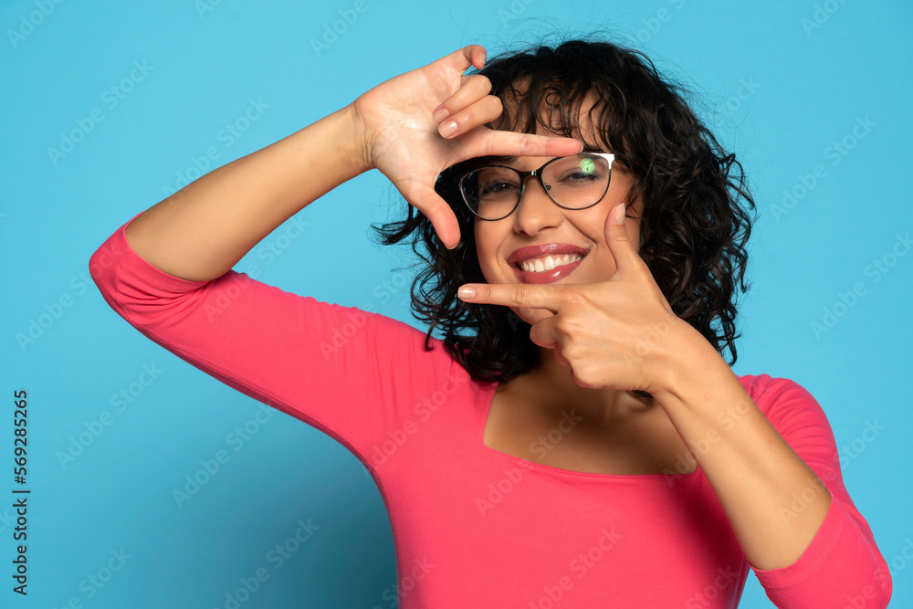 Young exotic brunette woman making a hand frame, composing picture ...