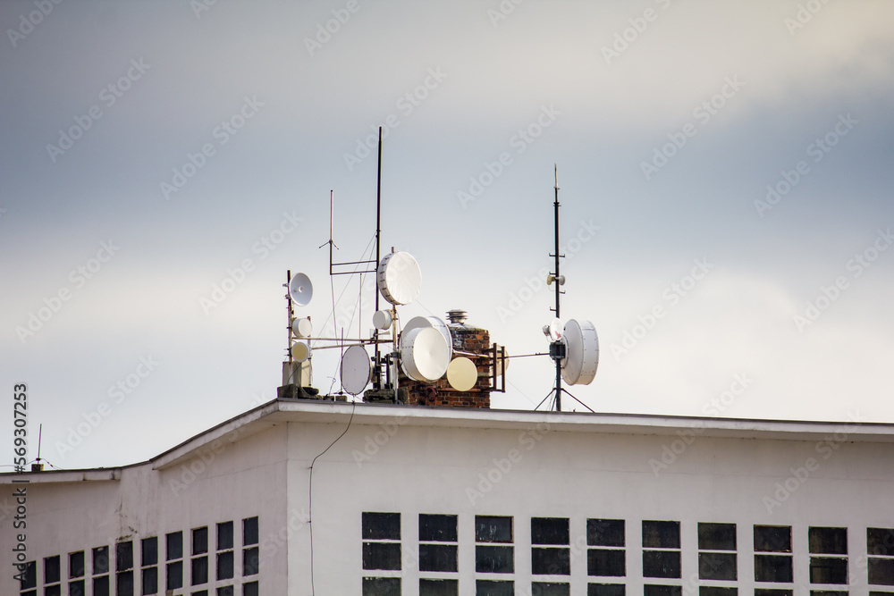 Cellular signal receiving stations and satellite dishes on the roof of ...