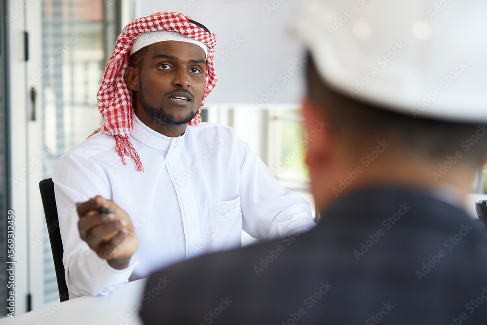 young African muslim businessman in white traditional outfit, talking ...