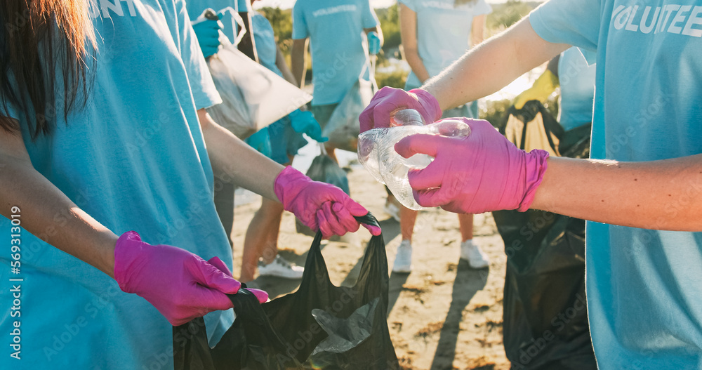 Pretty Caucasian female volunteers collecting garbage, rubbish in a ...