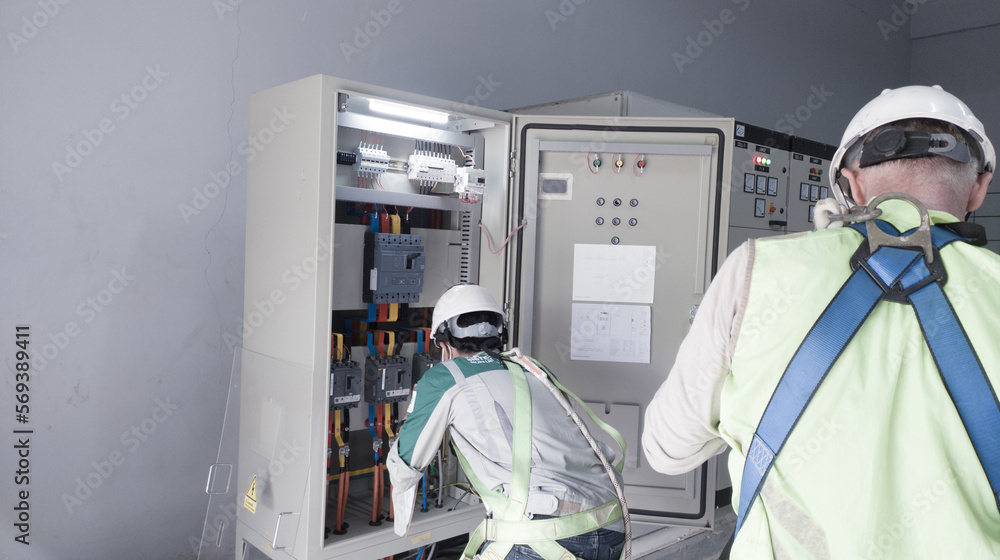 Technicians Check and service the Electrical panel control on the main ...