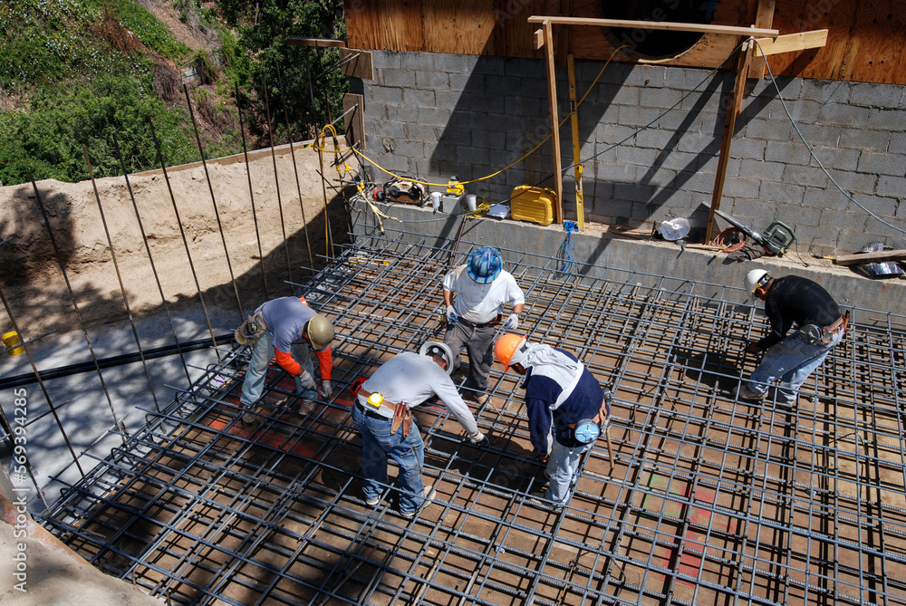 Photo & Art Print Concrete crew preparing forms and steel for a thick ...