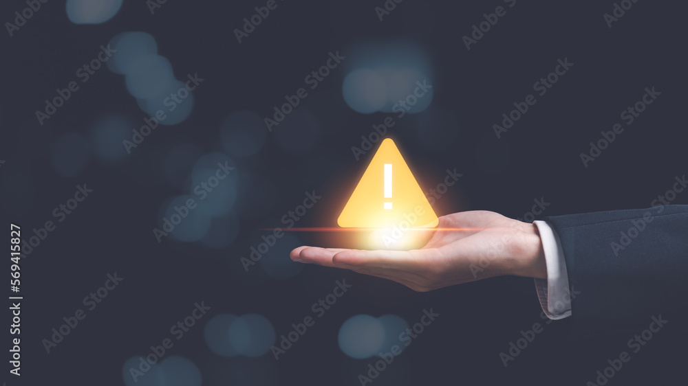 businessman showing warning icon, exclamation mark,alarm,computer virus ...