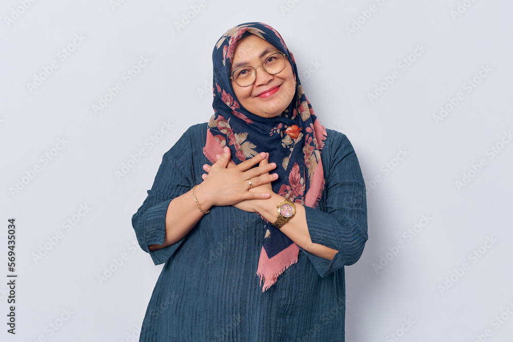 Elderly smiling Asian Muslim woman 50s wearing hijab in glasses holding ...