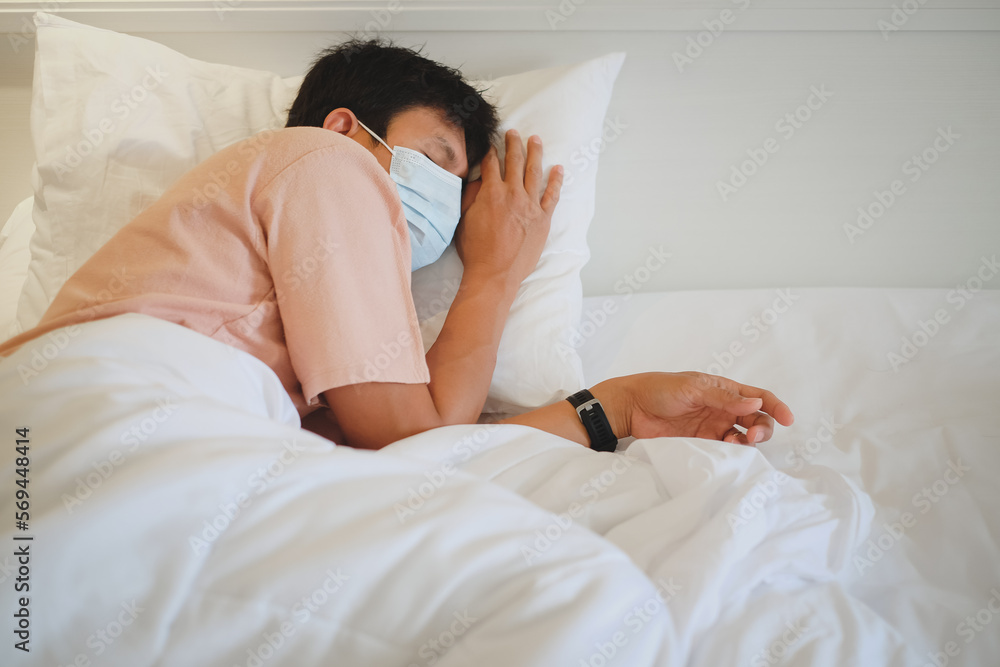 Asian male patient sleeping on bed with face mask in recovery room in ...