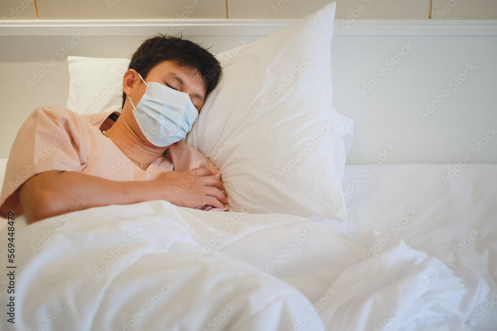 Asian male patient sleeping on bed with face mask in recovery room in ...
