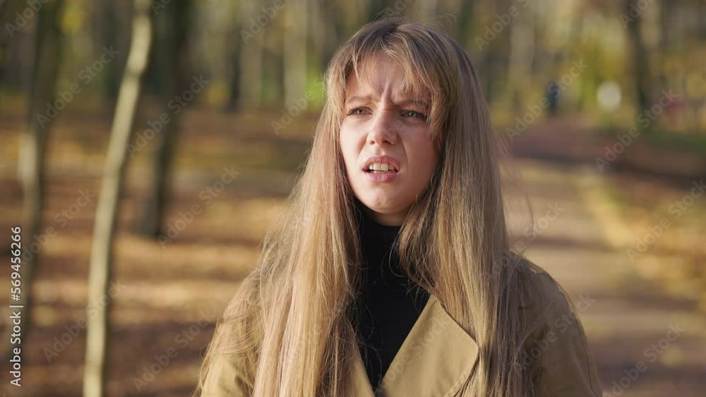 Vidéo Stock Side view of tired woman standing in park, touching head ...