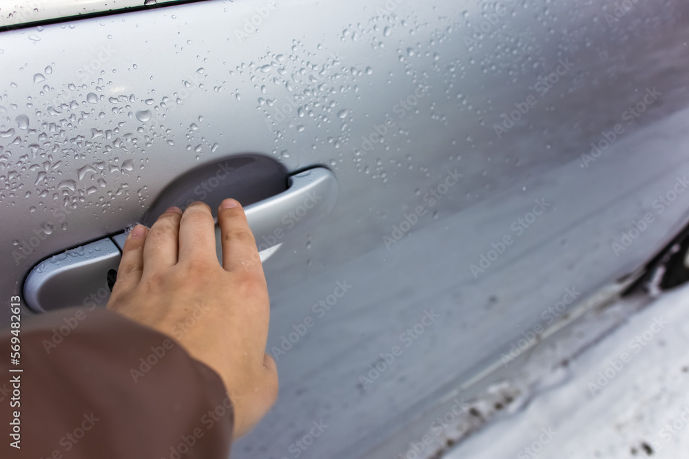 Opens the car door.Hand on the handle of the car.Open the door.Ride in ...