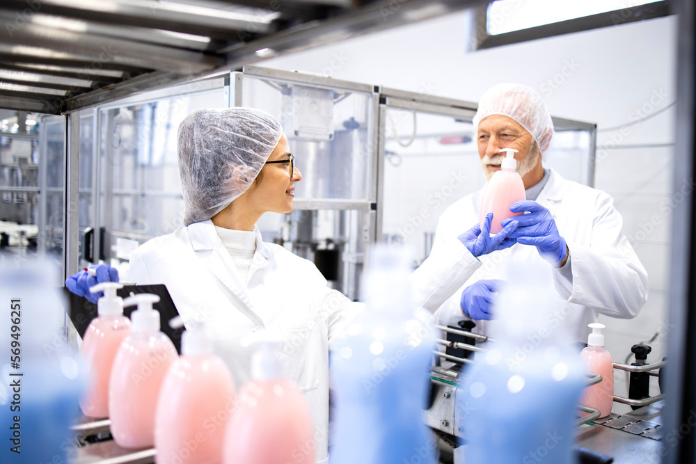 Team of factory workers producing cleaning chemicals like shampoo ...