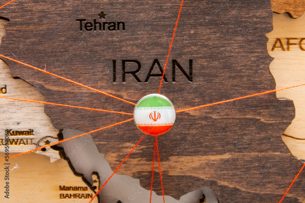 Iran flag on the pushpin and red threads on the wooden map. Travel or ... Iran flag on the pushpin and red threads on the wooden map. Travel or ...
