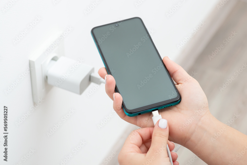 Inserting USB type-c cable to the phone for charging. Charging phone ...