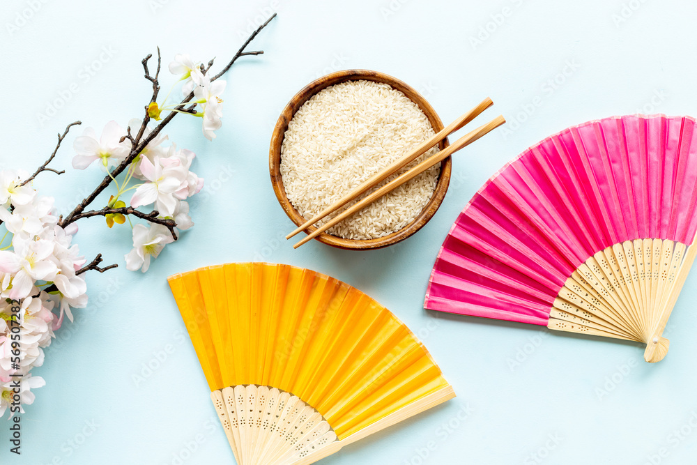 Chinese or Japanese background with bowl of rice and fan, top view ...