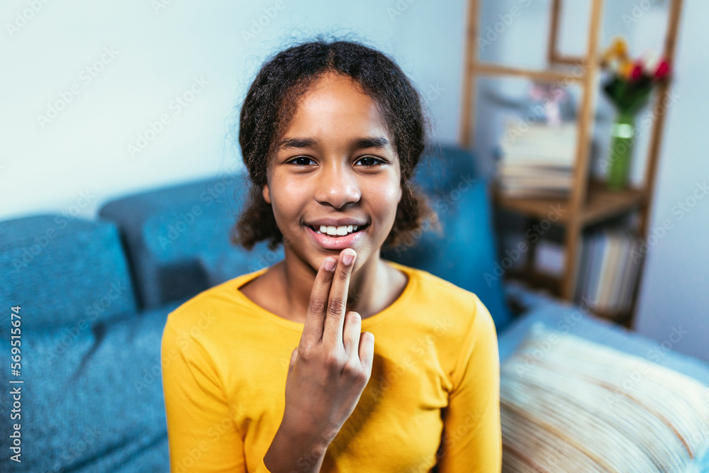 Beautiful smiling black deaf girl using sign language at home Stock ...