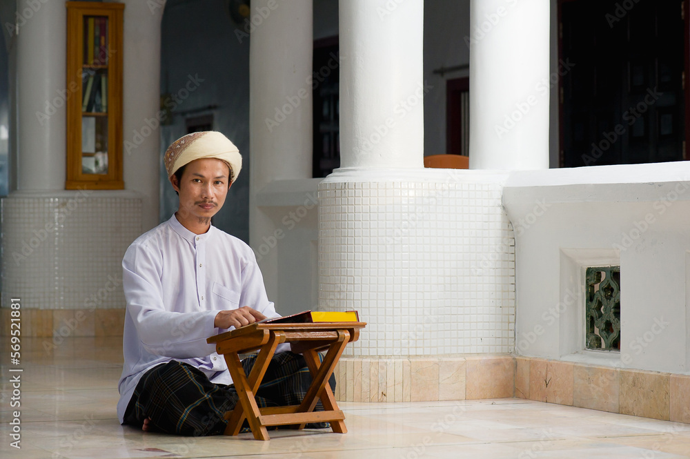 Religious muslim islam man in white session sit on the floor and read ...