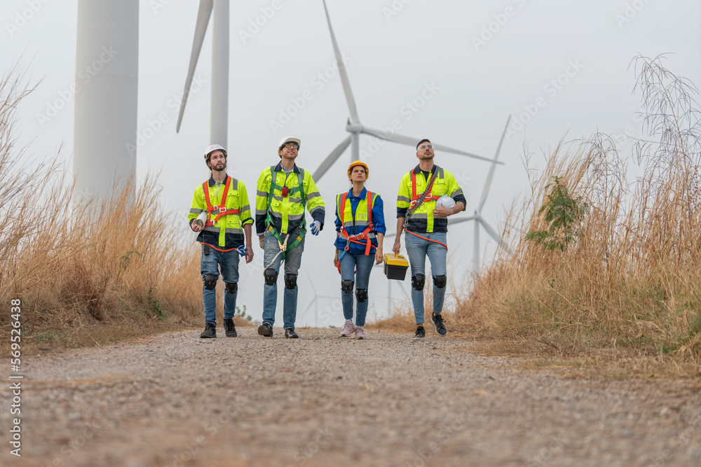 Engineers windmill team wearing uniform and helmet walking survey work ...